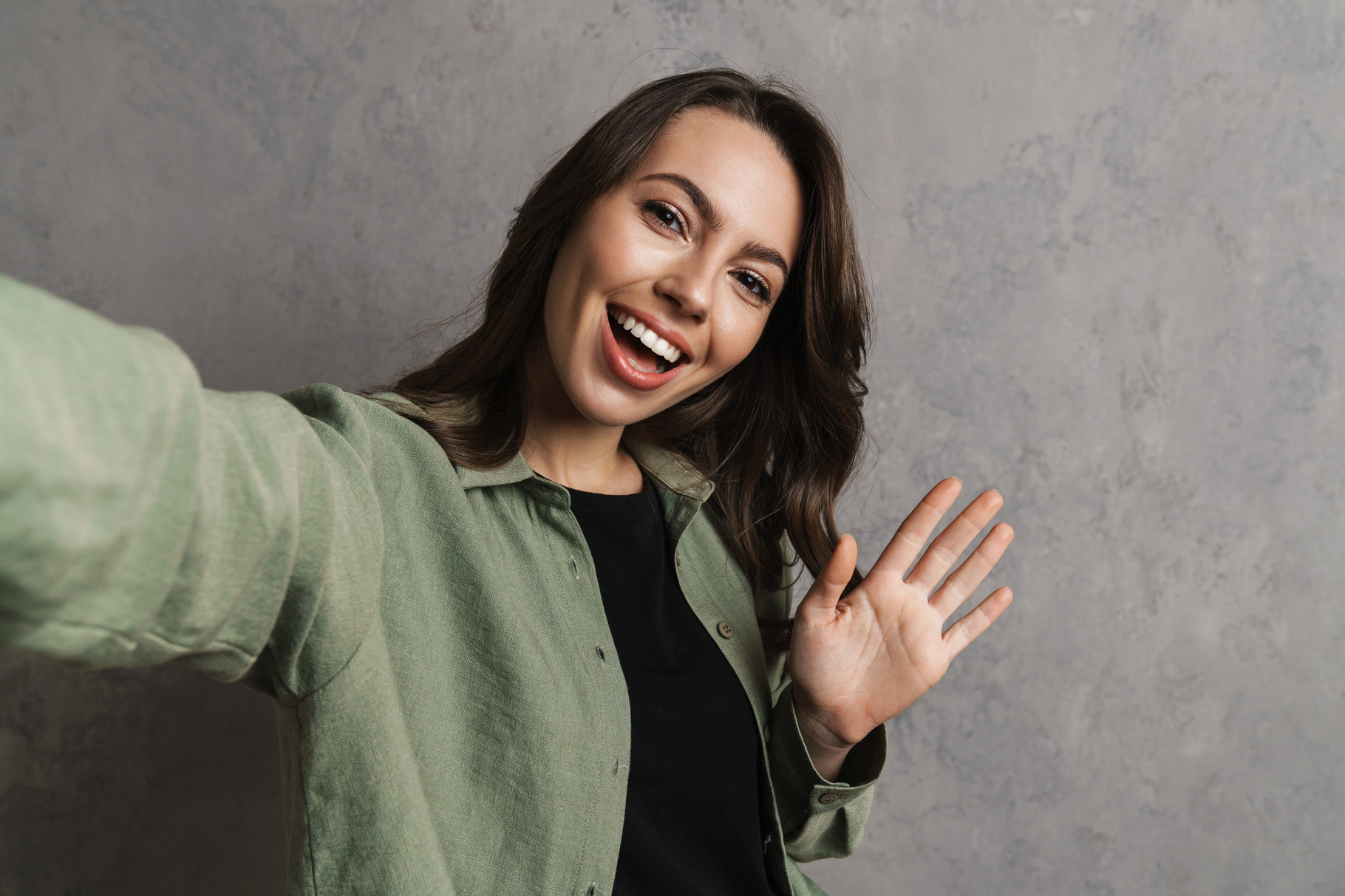Happy beautiful girl waving hand while taking selfie photo, a Sports ...