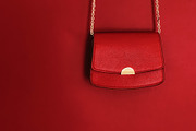 Red fashionable leather purse with gold details as designer bag, a ...