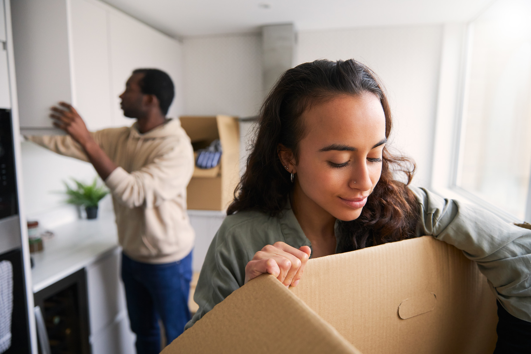 Excited Young Couple In New Home Unpacking Removal Boxes In Kitchen ...