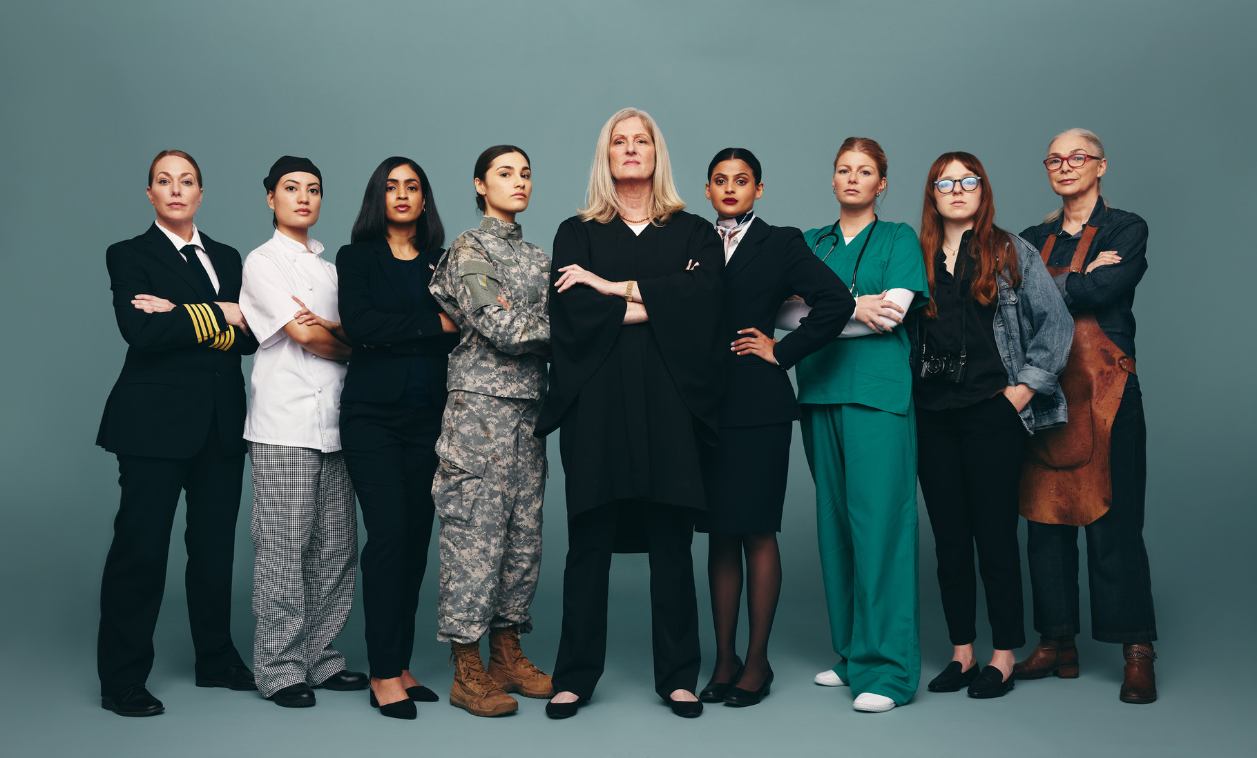 Group of diverse female professionals standing together in a stu ...