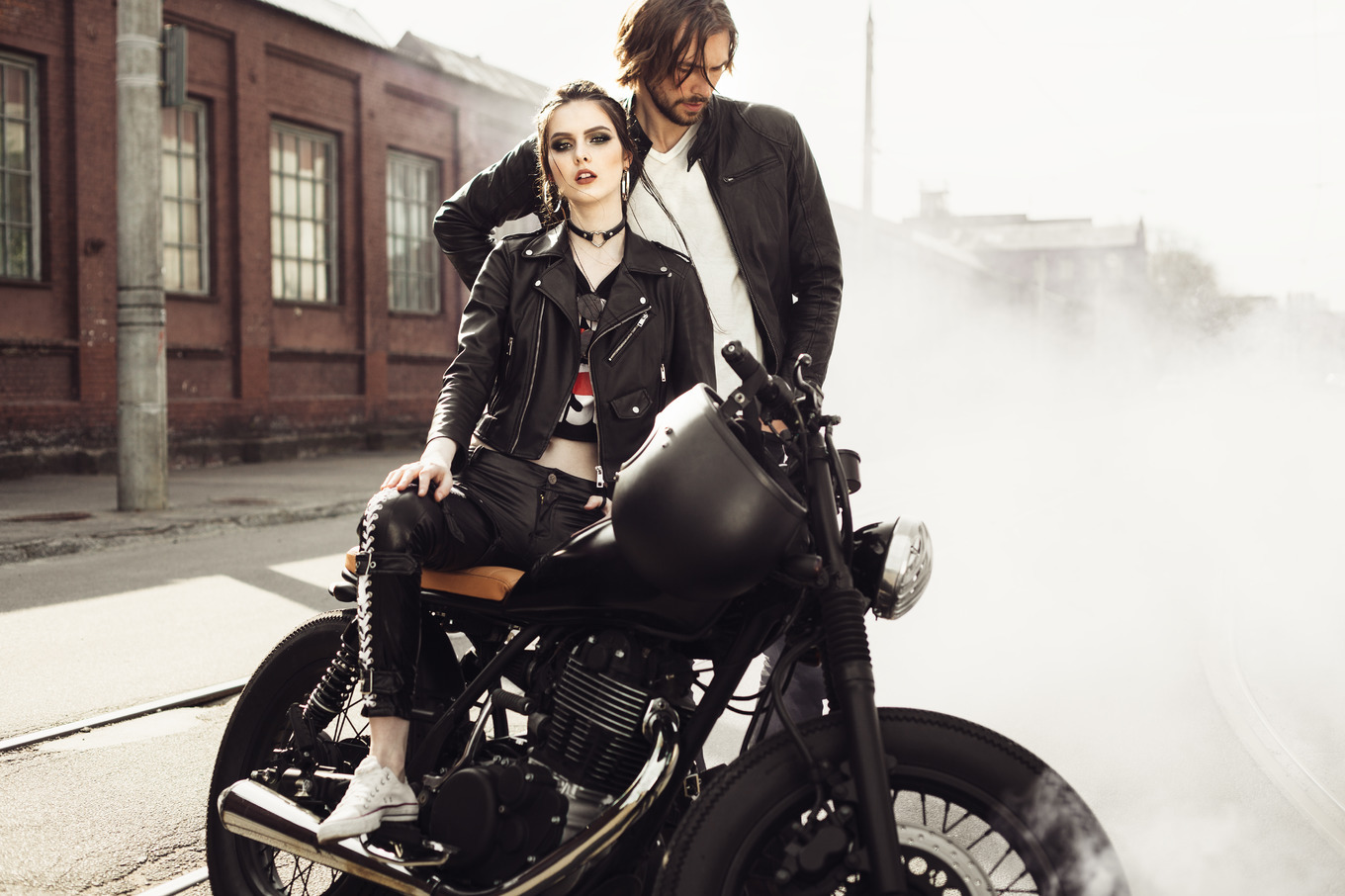 Couple in love and vintage custom motorcycle containing moto, caferacer ...