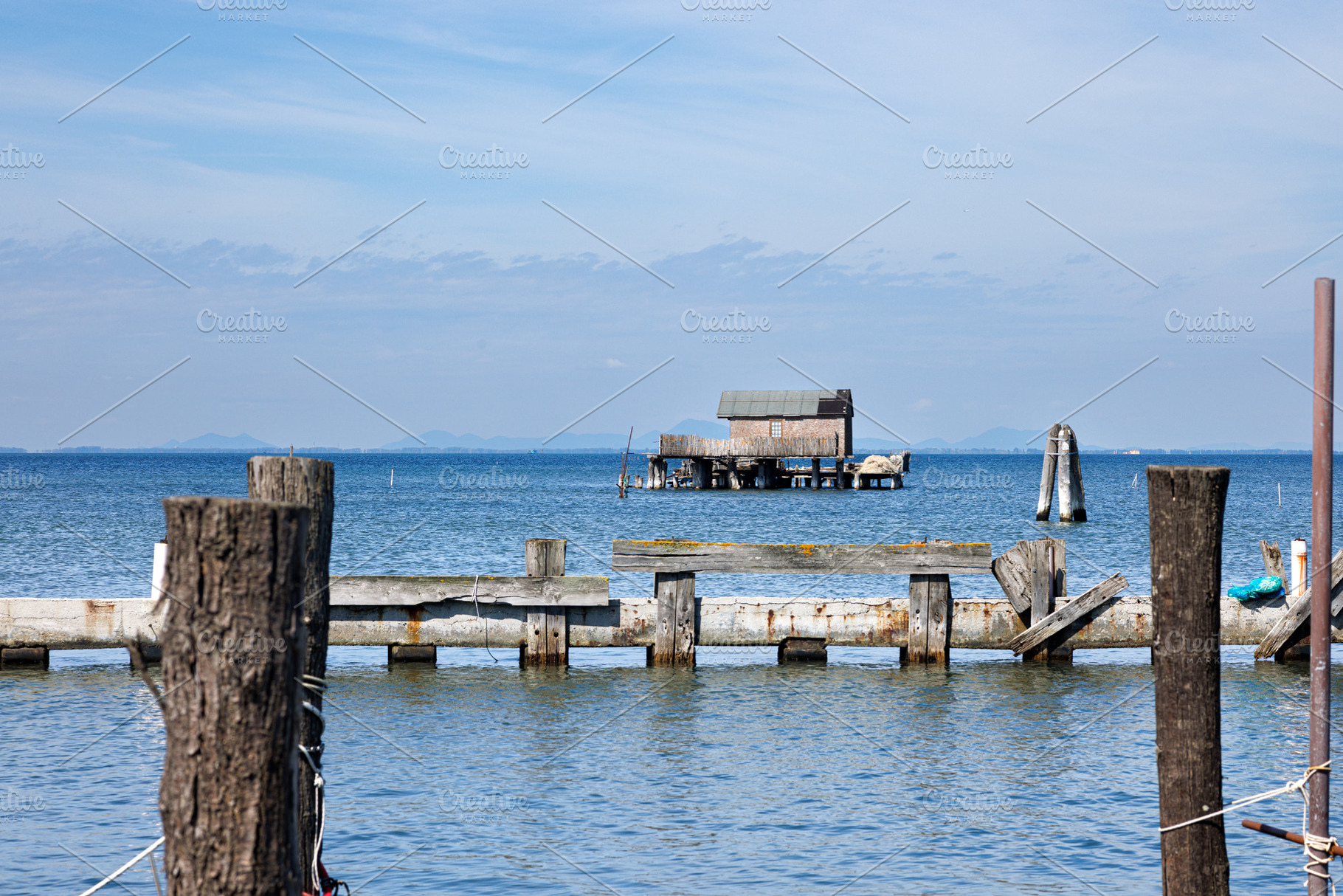 A rustic wooden stilt house and boat with fishing nets, an Architecture ...