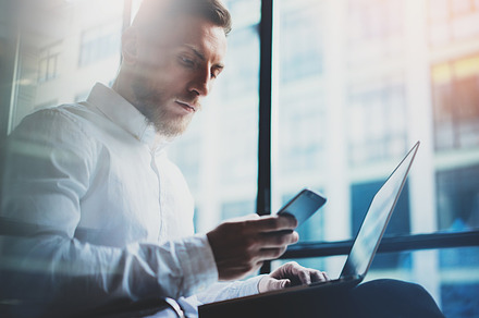 Stylish banker making mobile call at modern loft after work day.Man ...
