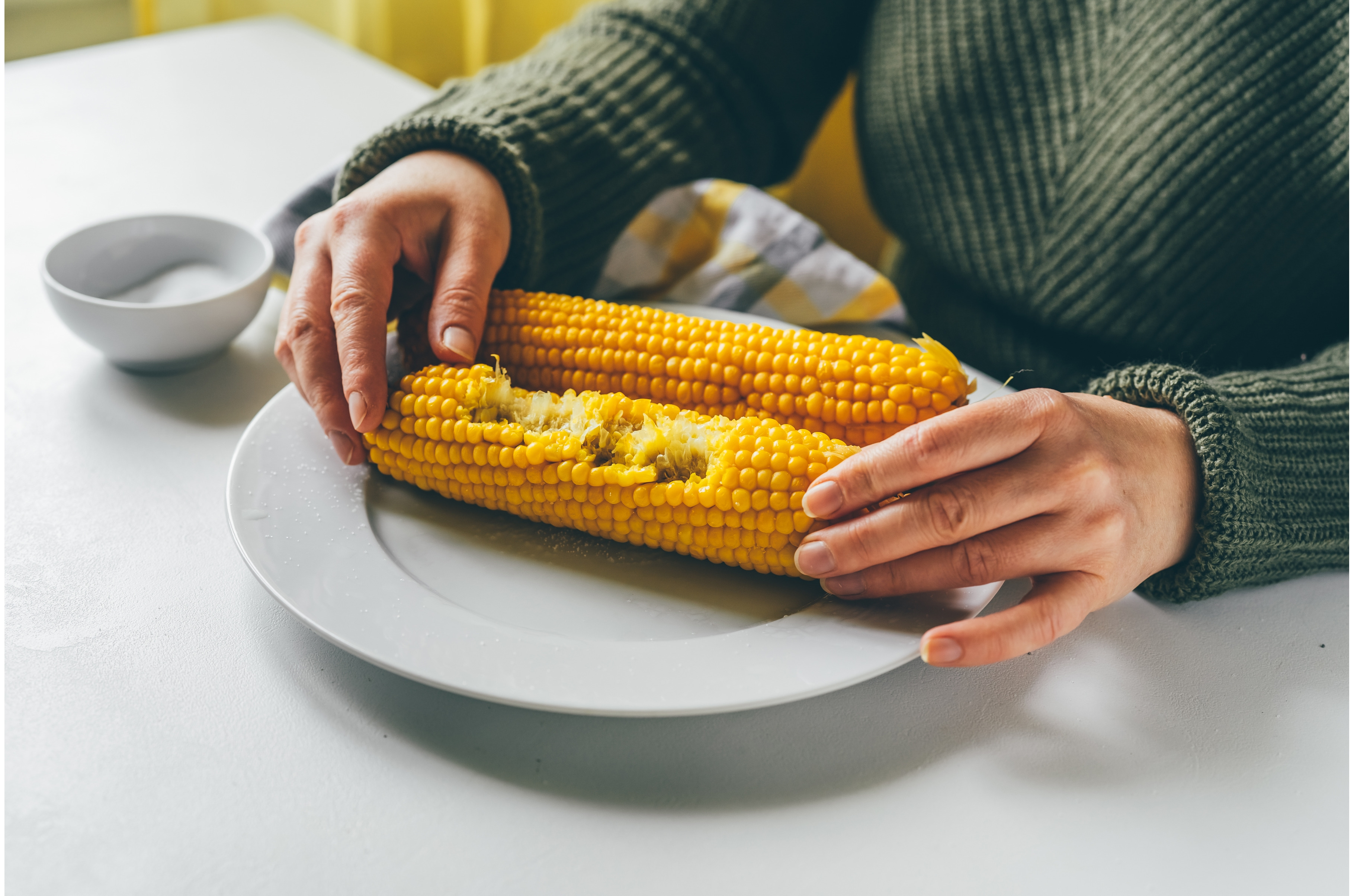Eating prepared corn cobs at the, a Person Photo by Yummypic