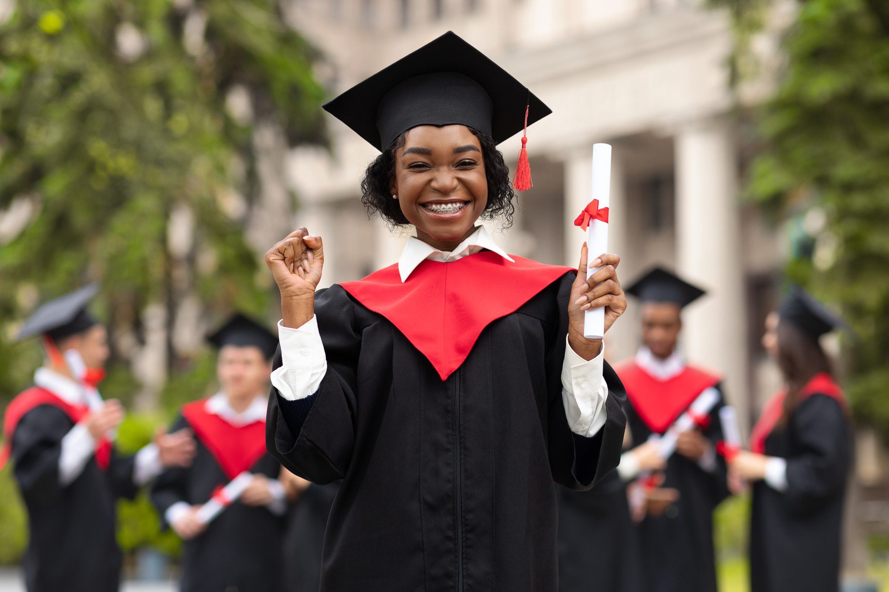 Cheerful african american young lady in graduation costume, a Photo by ...