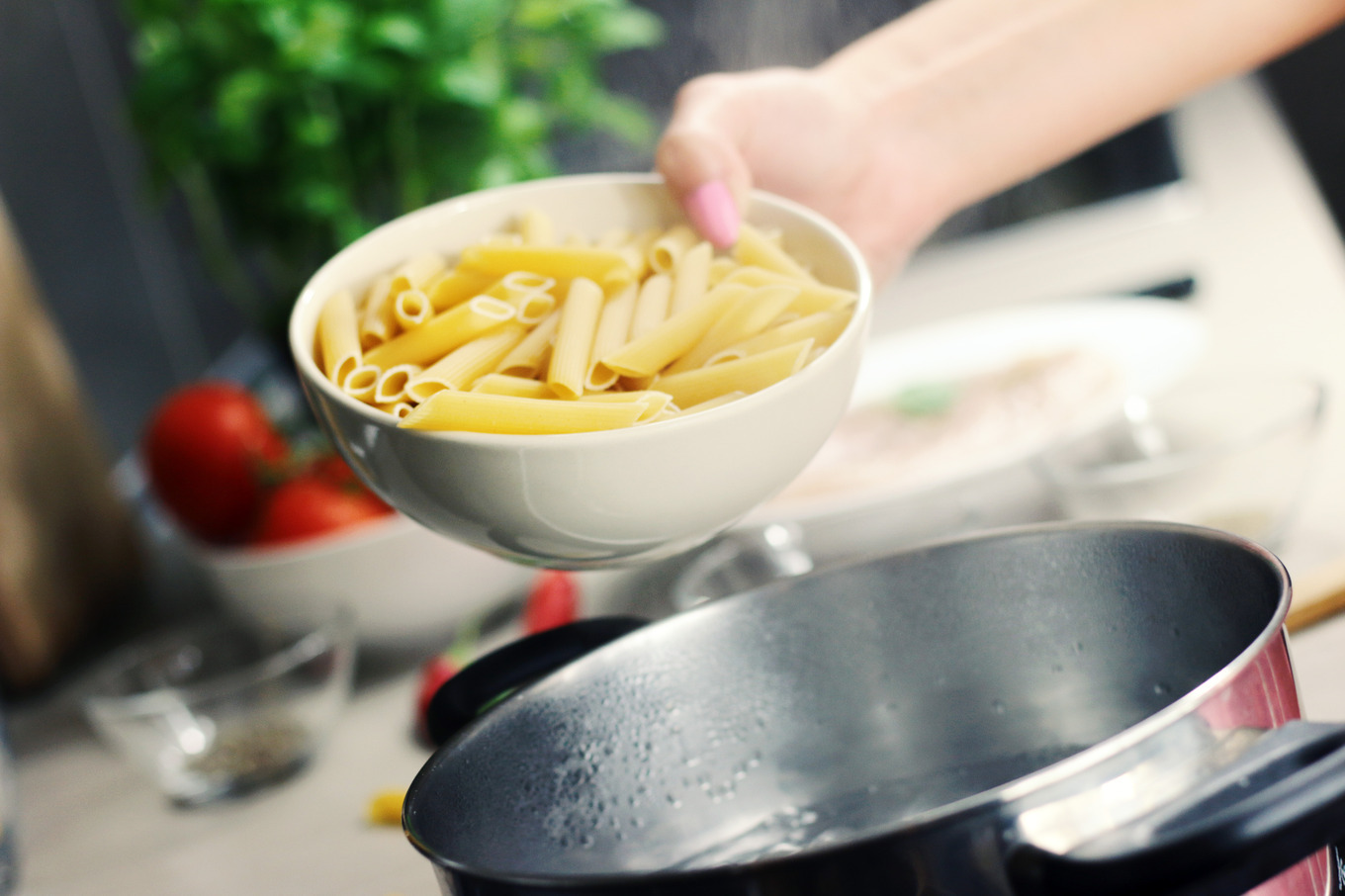 Cooking pasta in the kitchen, a Food & Drink Photo by StartMockups.com