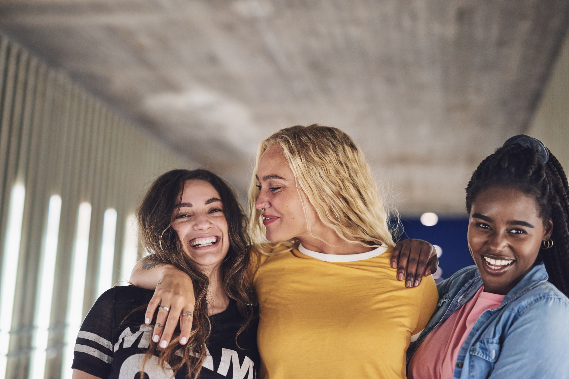 Laughing girlfriends walking together in the city at night stock photo ...