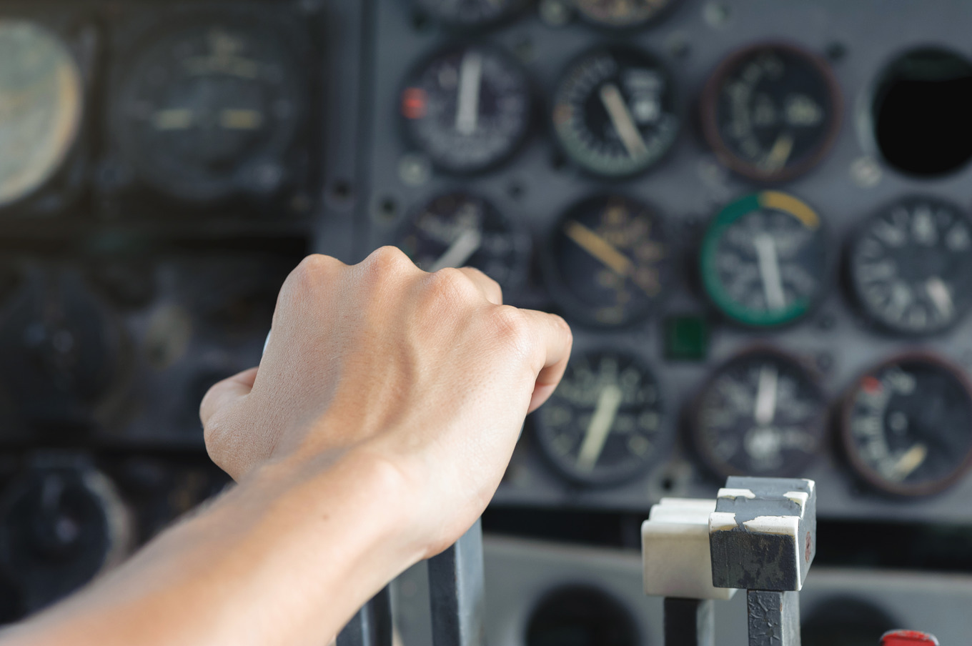 Airplane cockpit thrust levers with hand on top for takeoff containing ...