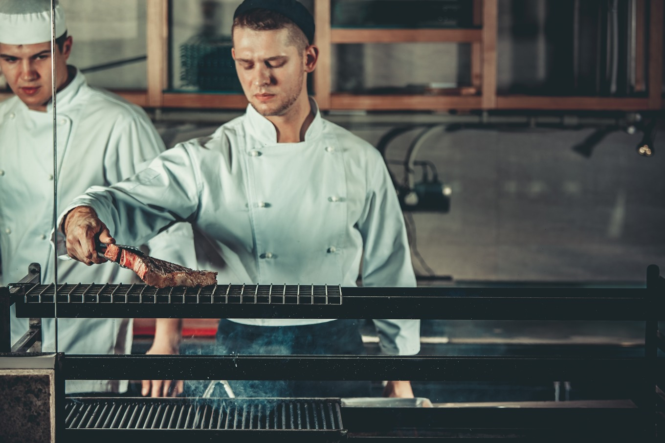 Preparing traditional beef steak containing chef, meat, and food, a ...