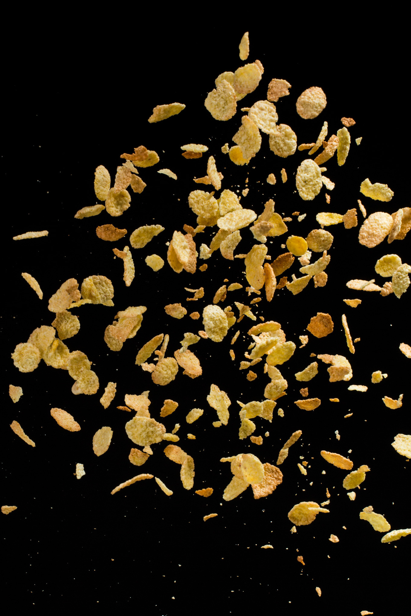 Flying corn flakes isolated on black featuring flake, corn, and flying ...