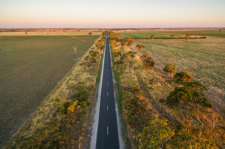 Straight road in rural area featuring dusk, landscape, and meadow ...