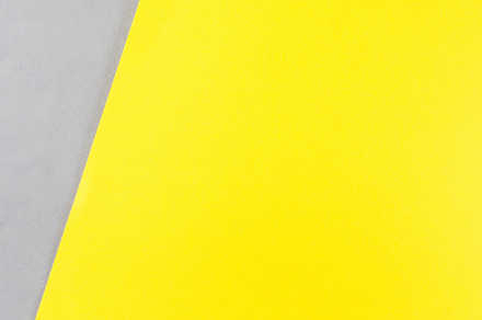 Diagonal with yellow paper and gray concrete texture, blank background ...