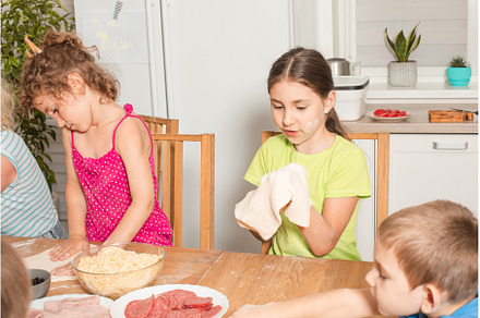 Happy kids sit at a table in the, a Person Photo by oksix