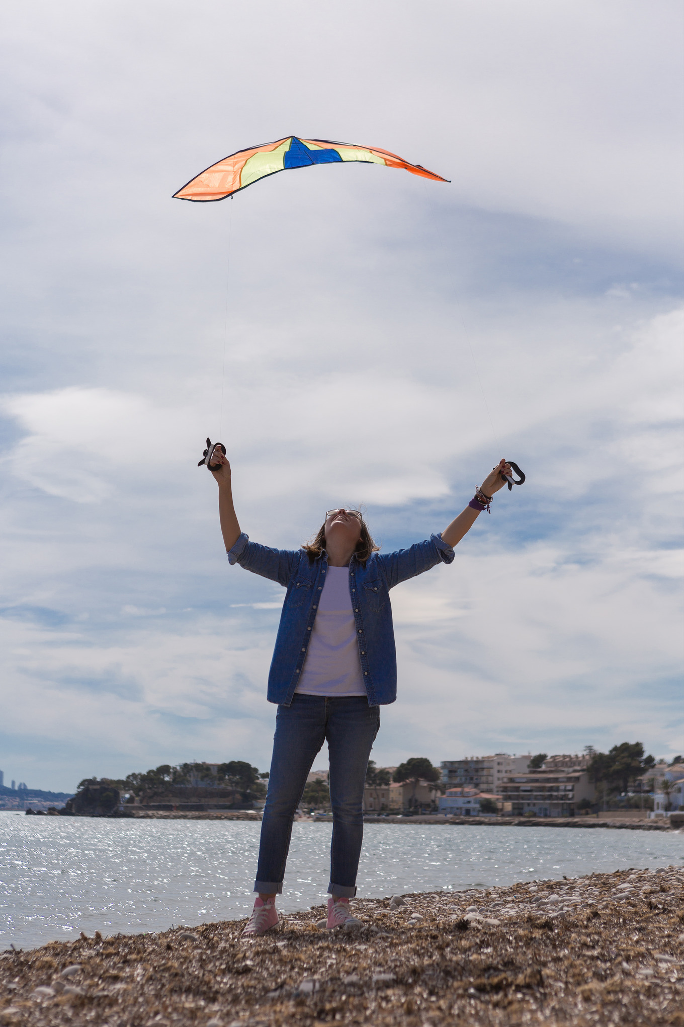 Woman with kite on the beach featuring fly, kite, and looking up, a ...