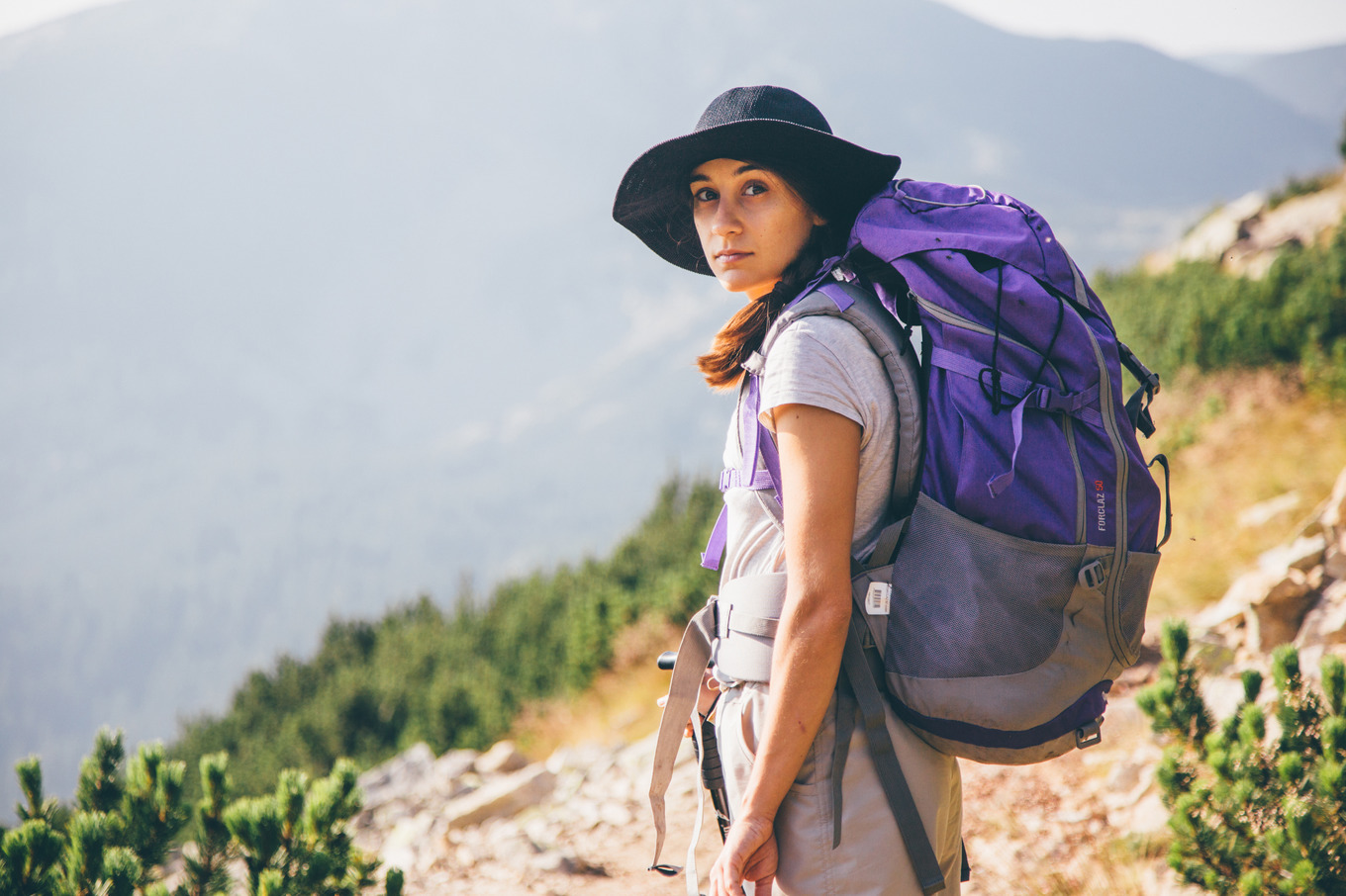 Young woman with a mountain backpack, a Holiday Photo by Mukuko Studio