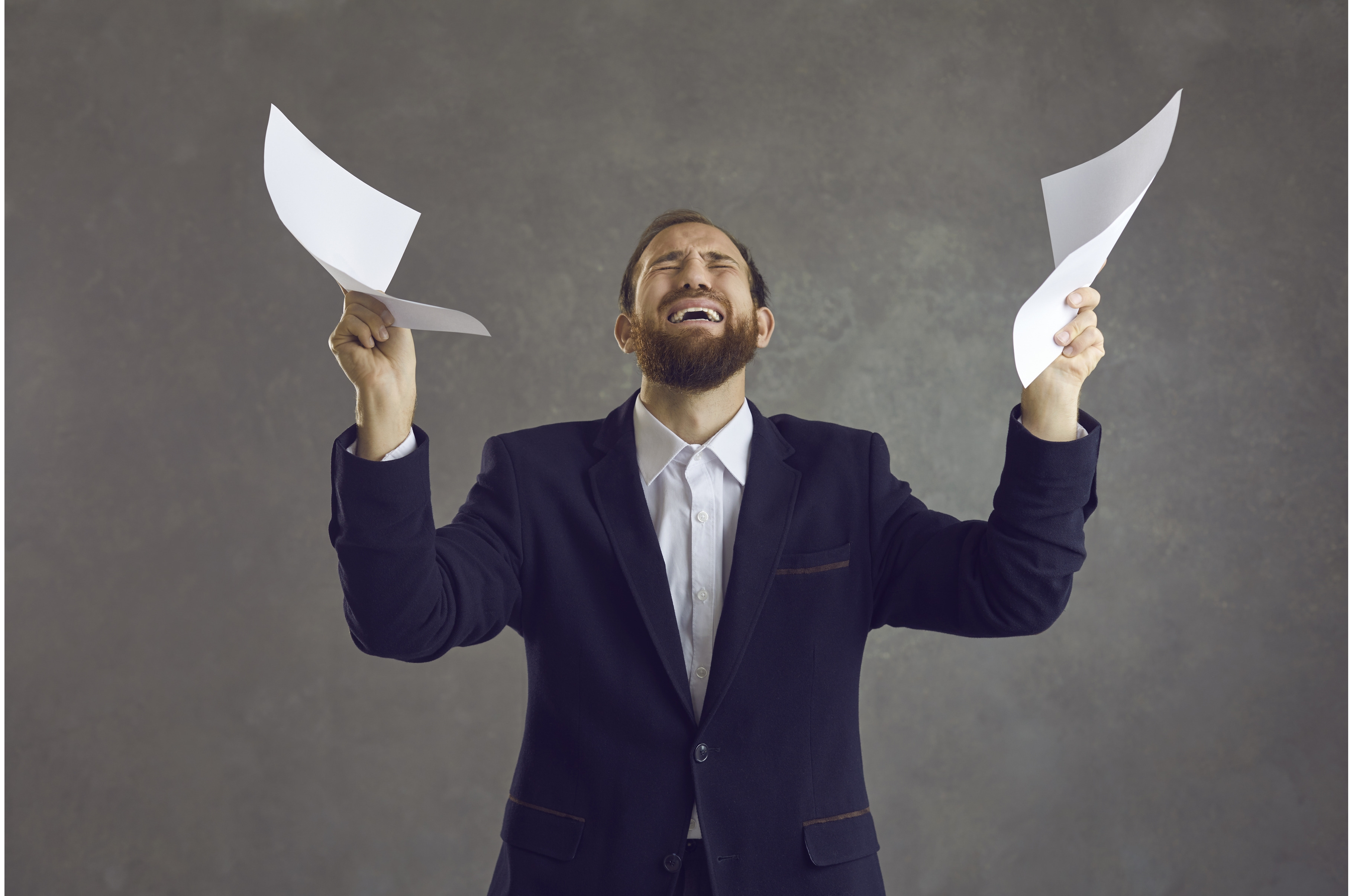Young man holding sheets of paper, a Person Photo by StudioRomantic