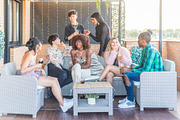 Multiethnic friends having drink in party at day | People Images ...