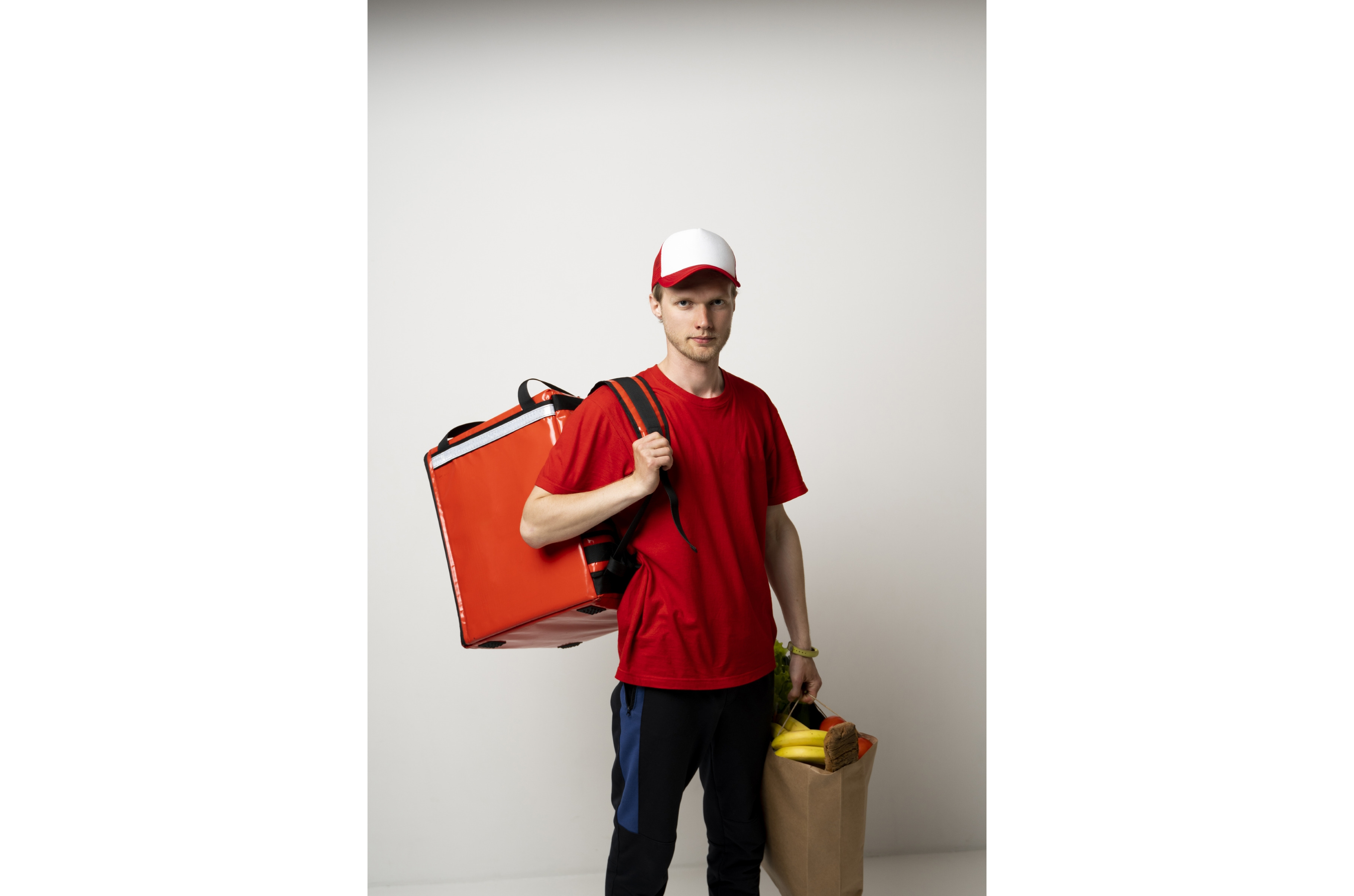 Delivery man in red uniform with a, a Business Photo by ...