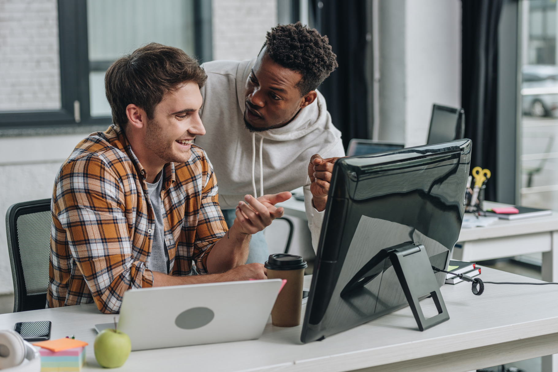 two smiling multicultural programmer, a Person Photo by LightField Studios