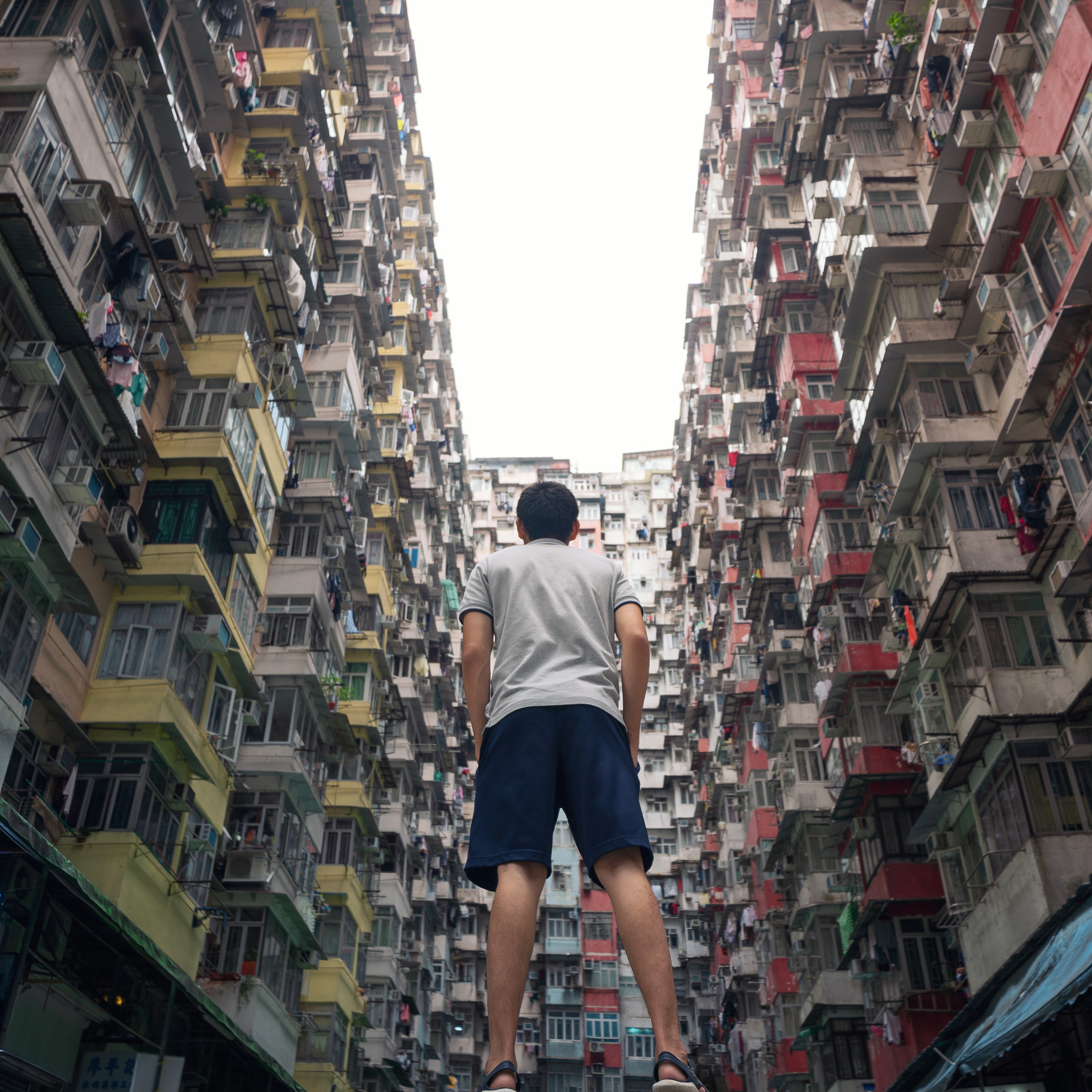 A tourist man with Yick Fat Building, an Architecture Photo by Tampatra