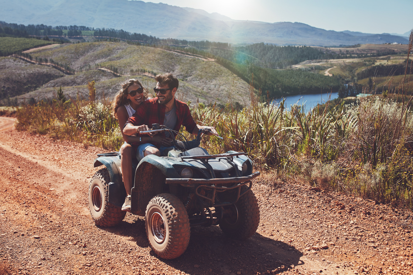 Happy couple riding on a quad bike, a Person Photo by Jacob Lund ...
