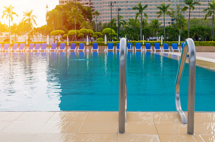 Blue swimming pool at hotel featuring pool, swimming, and tile, a ...