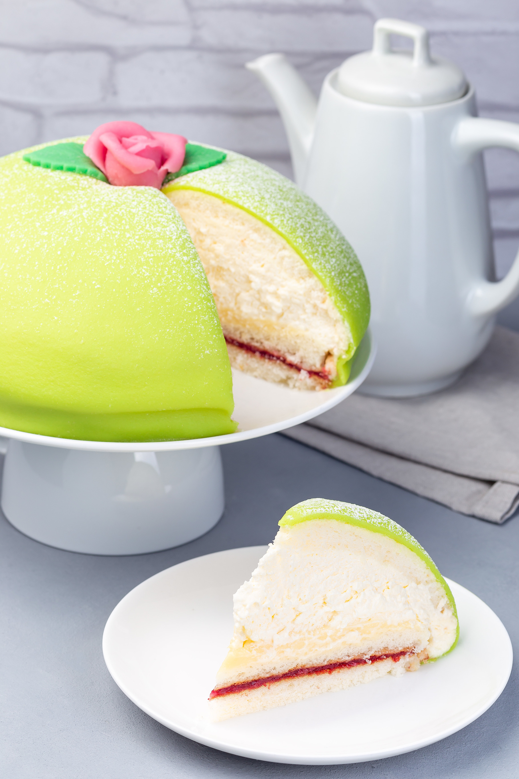 Slice of traditional Swedish dessert Princess cake with green marzipan ...