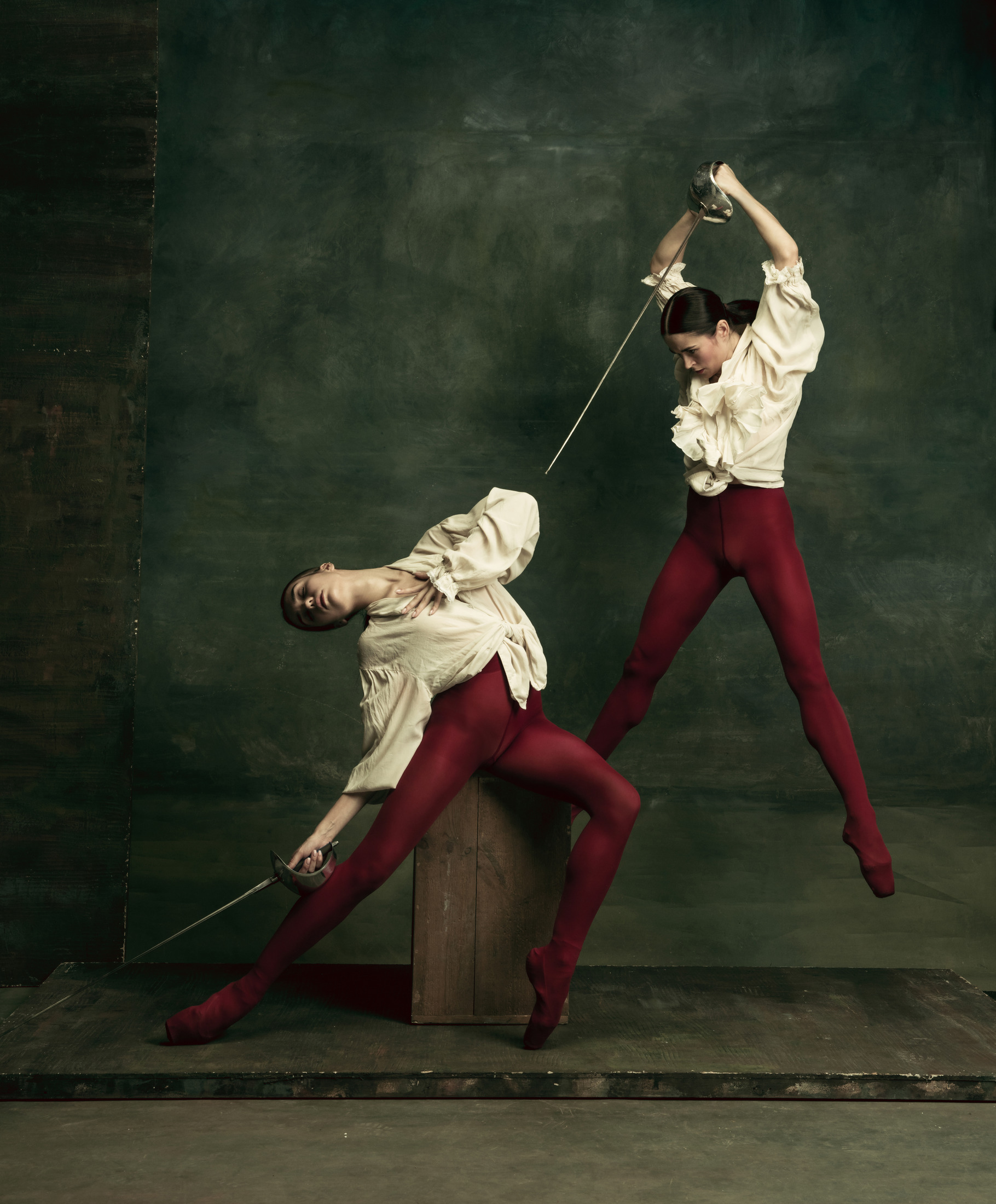 Two young female ballet dancers like duelists with swords. Ballet and ...
