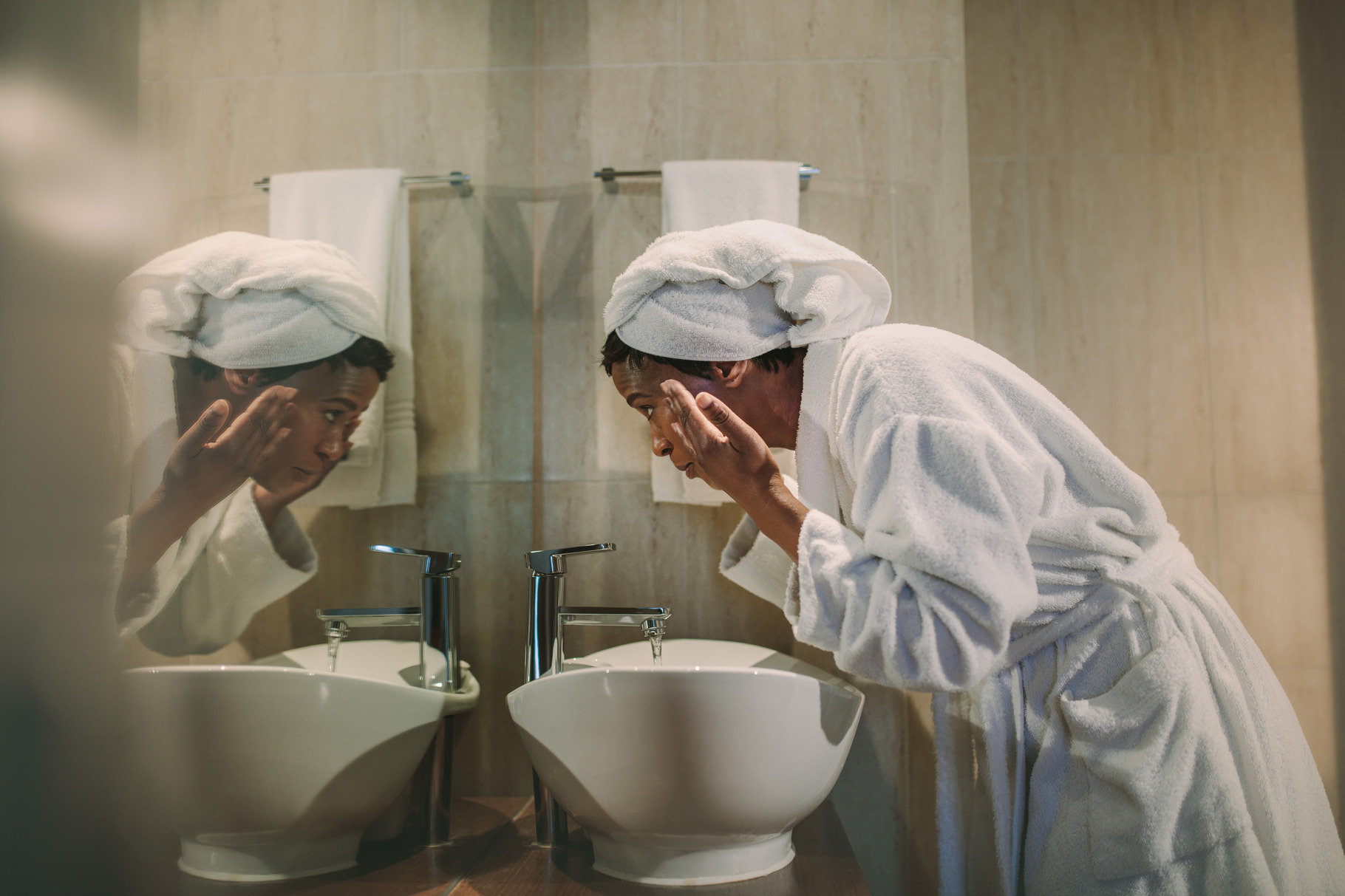 African woman washing her face, a Health & Medical Photo by Jacob Lund