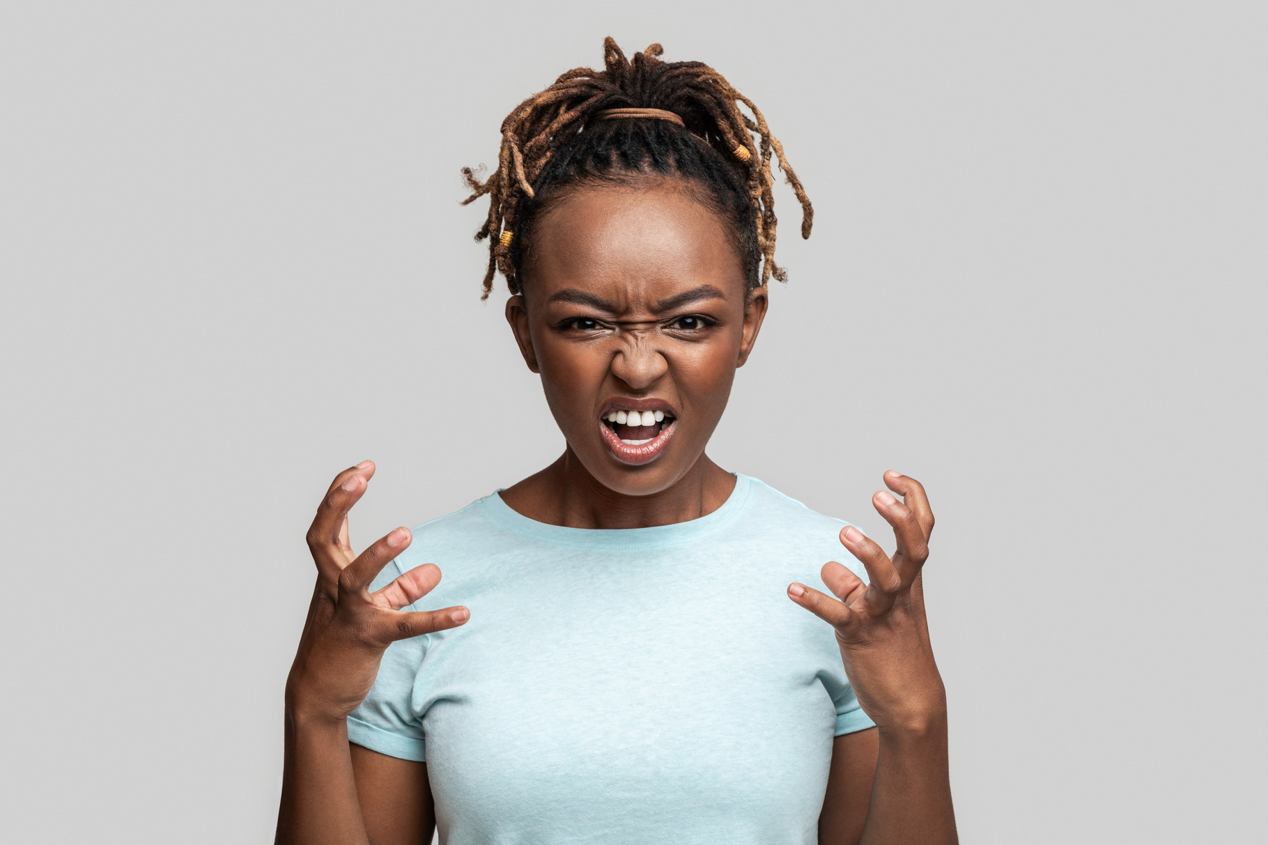 Angry furious young black girl screa, a Background Photo by Prostock-Studio