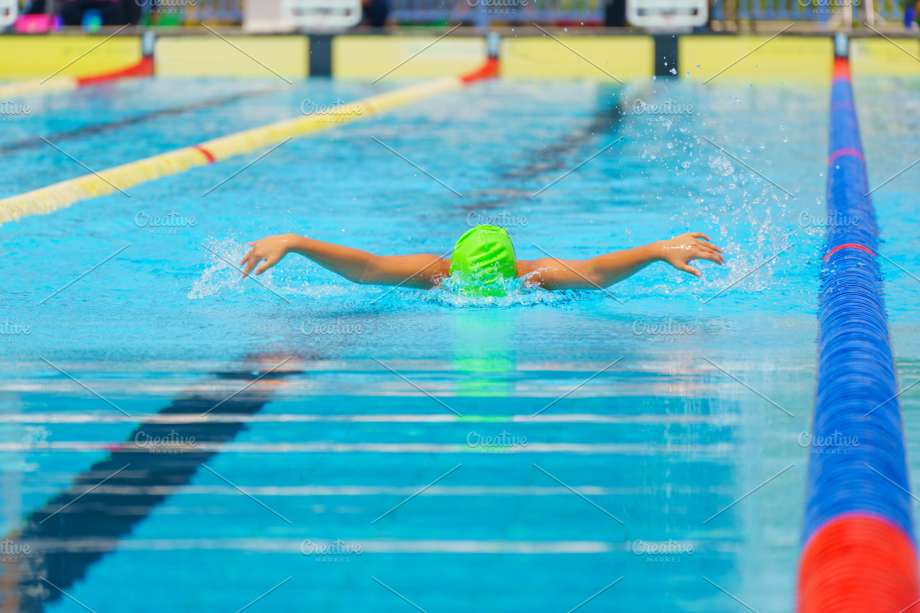 Swimmer child swims butterfly swimming style in a race swimming, a ...