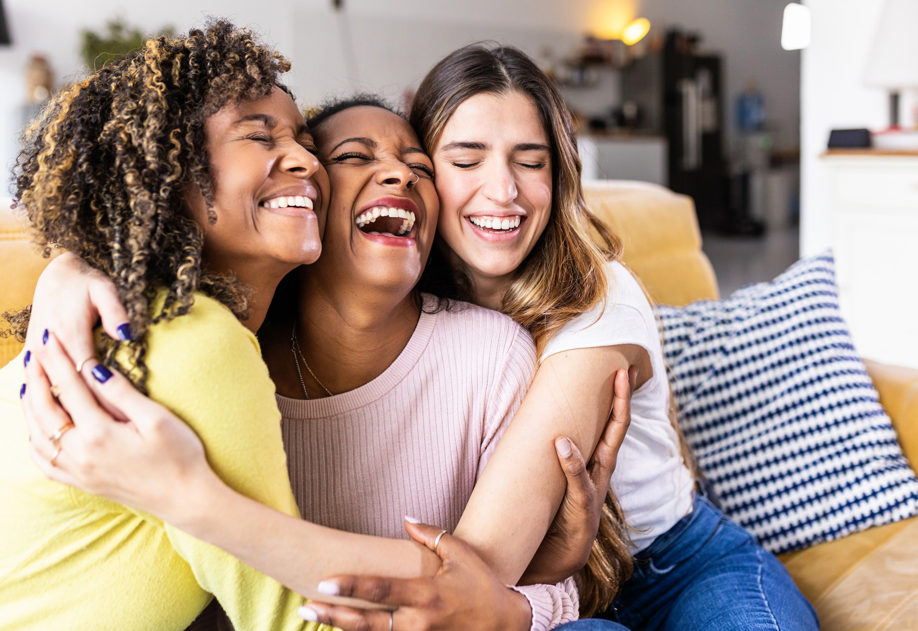 Three happy multiethnic female best friends laughing together - Diverse ...