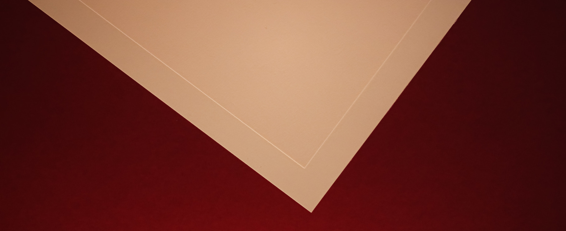 Blank A4 paper, beige on dark red background as office stationer, a ...