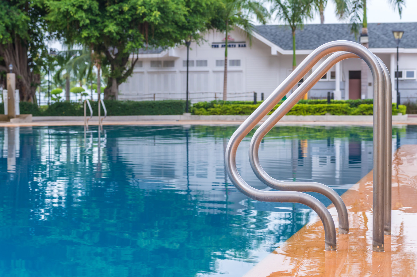 Blue swimming pool at hotel featuring pool, swimming, and tile, a ...