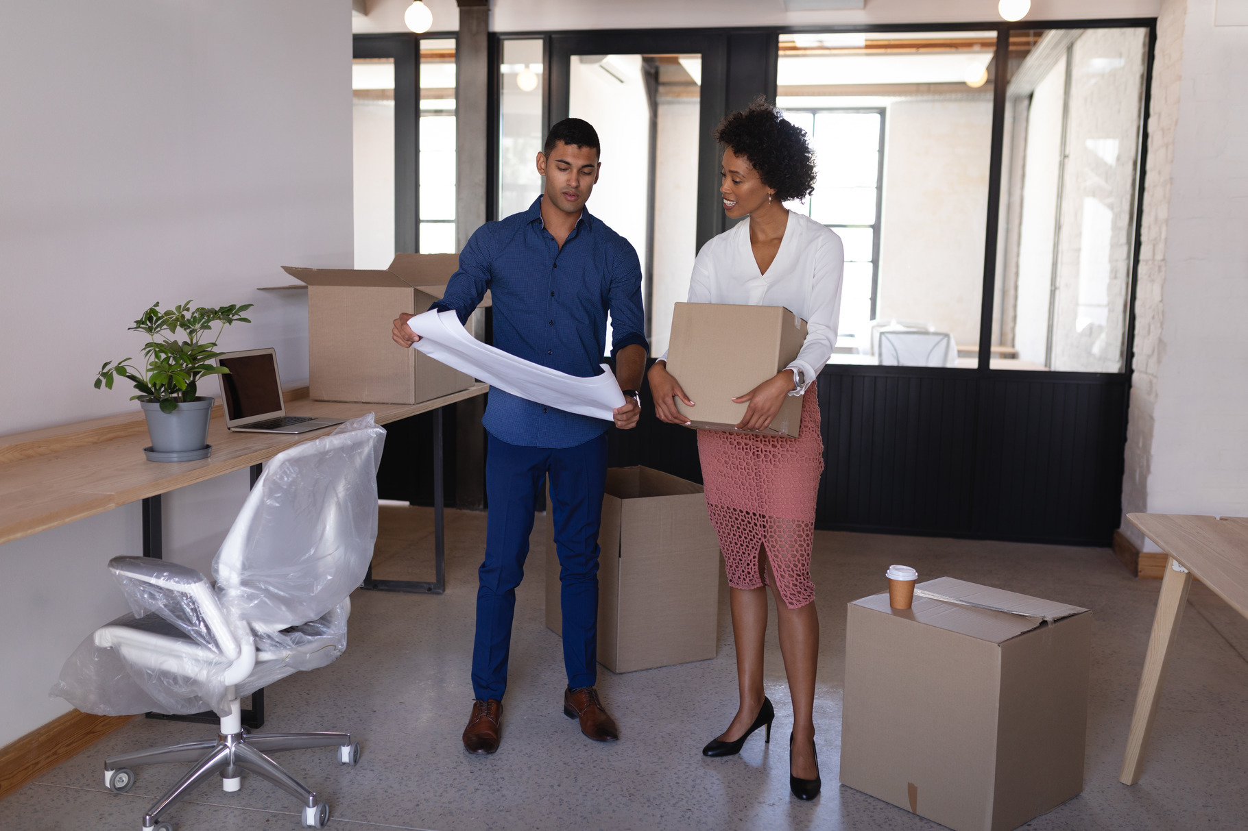 Business people move in a new office, a Photo by wavebreak