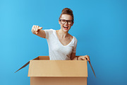 smiling young woman in cardboard box | People Images ~ Creative Market