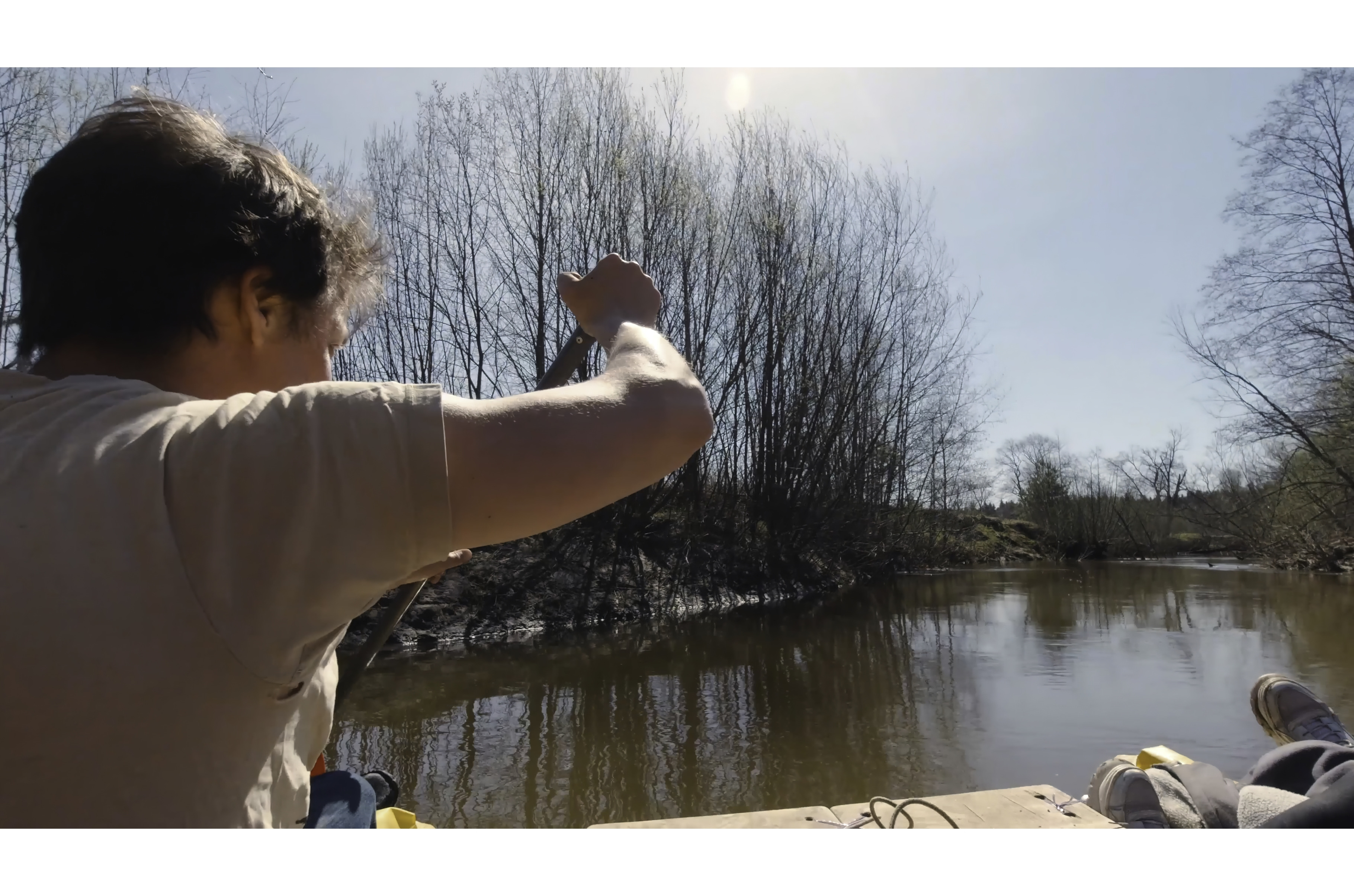 Man floating on raft with oar in, a Background Graphic by Media Whale Stock