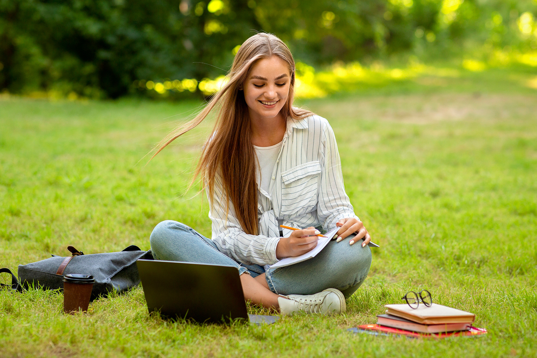 Beautiful student girl preparing for, a Photo by Prostock-Studio