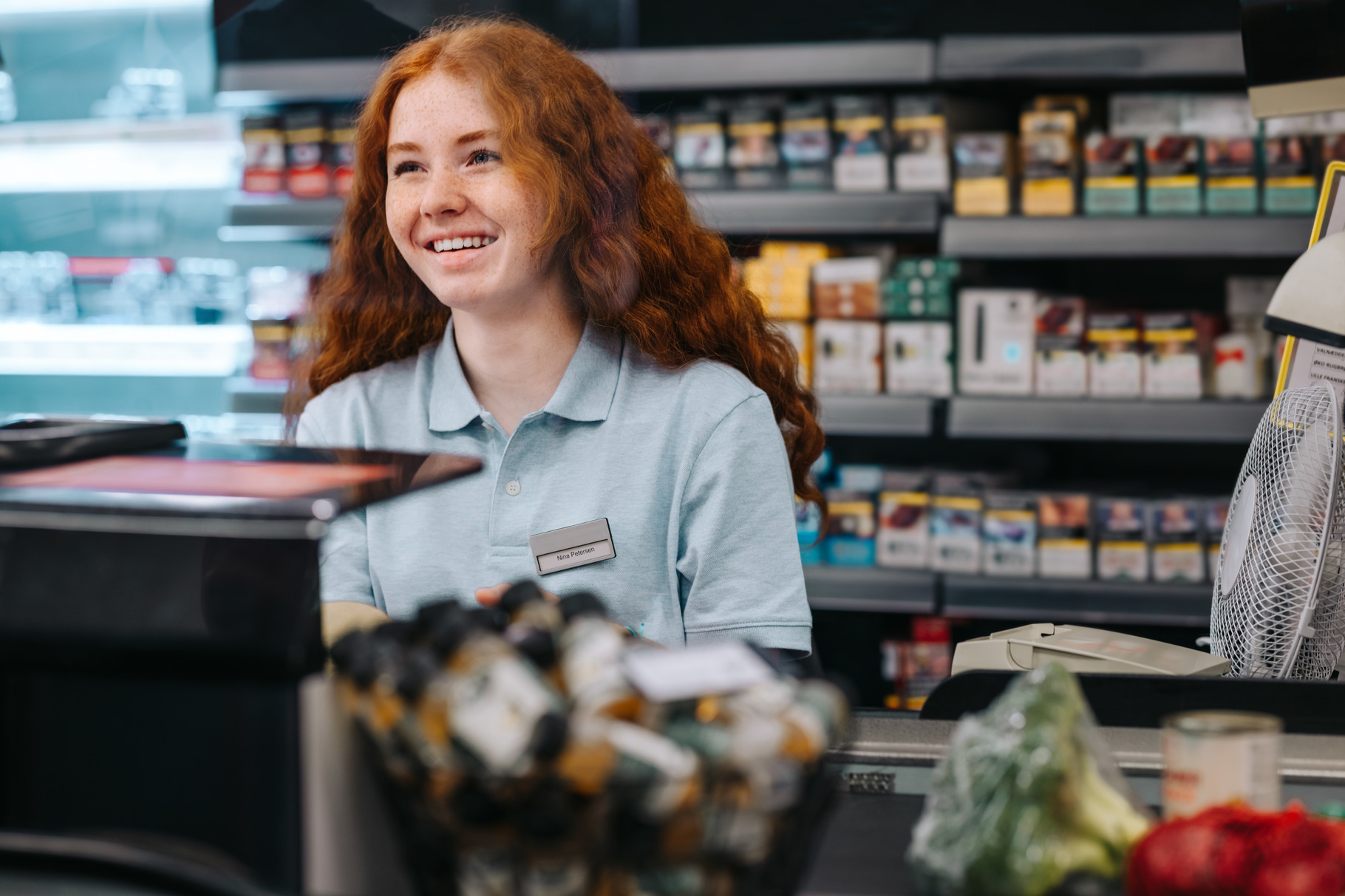 Woman working at supermarket checkout counter, a Person Photo by Jacob Lund