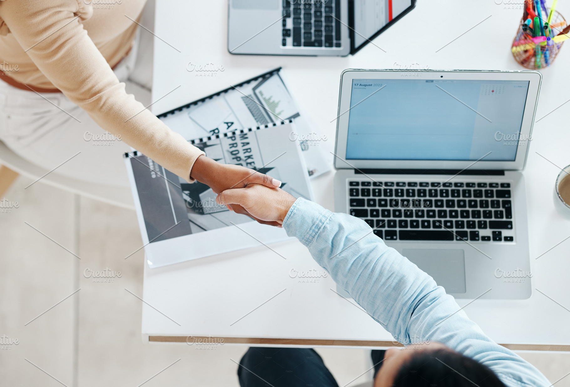 Creative business people, handshake and laptop above on mockup screen ...