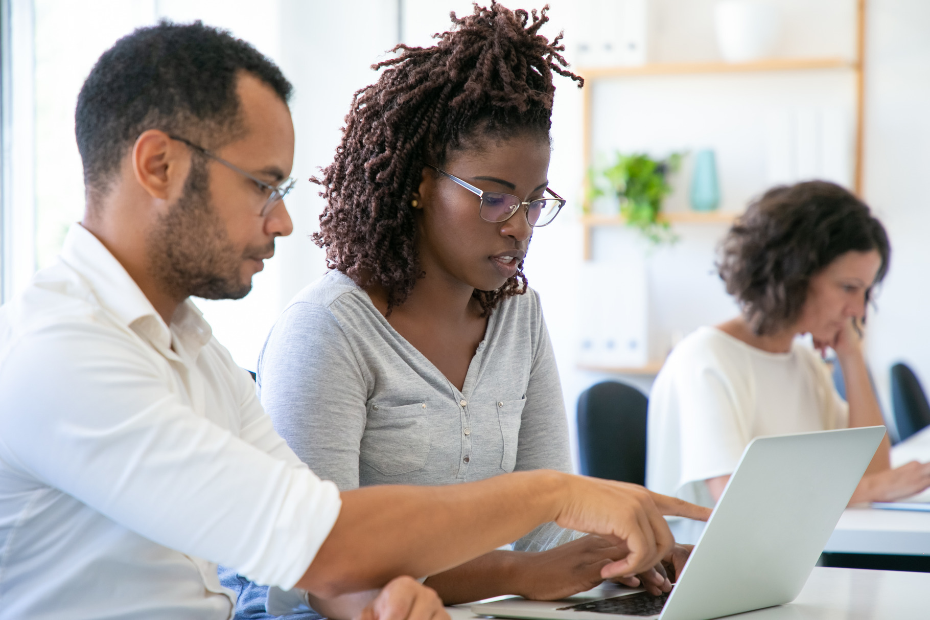 Employees working with laptop featuring concept, side view, and ...