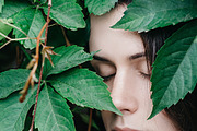 Girl in green leaves enjoying nature, a Person Photo by Yura_Yarema