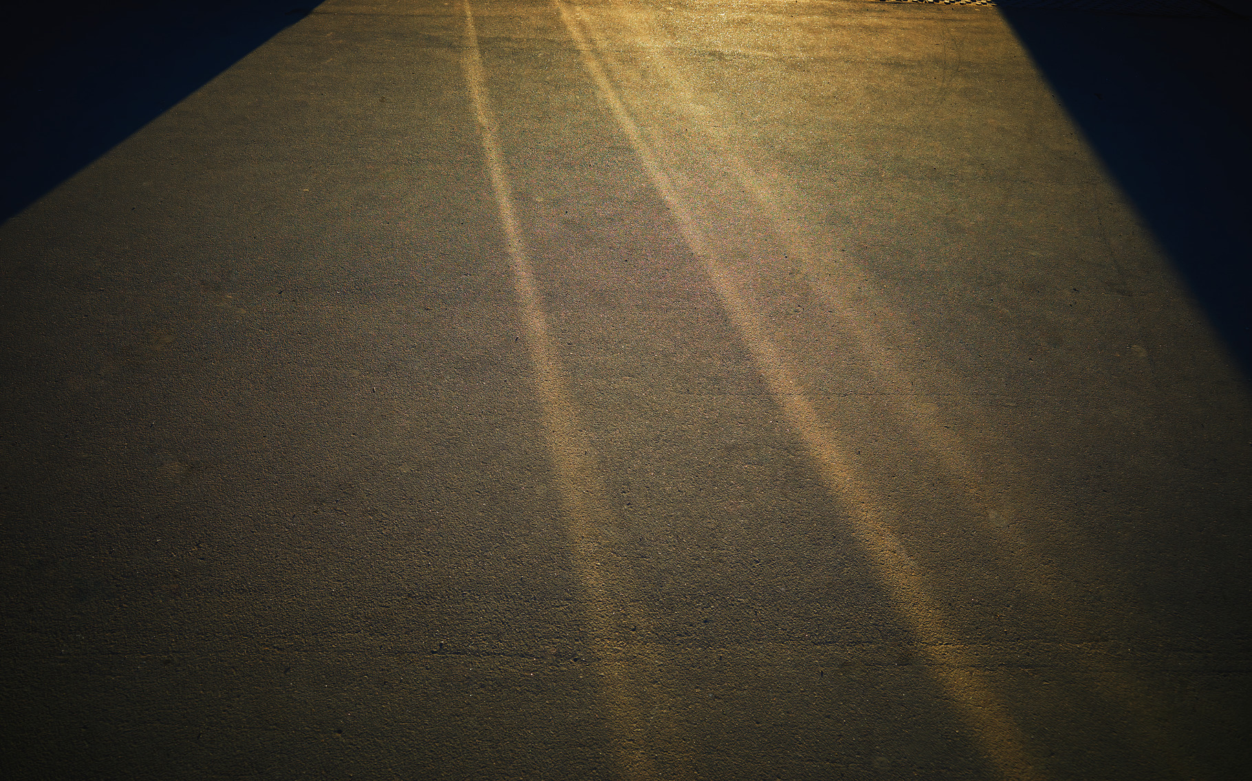 Vibrant light rays on street asphalt texture background, an Abstract ...